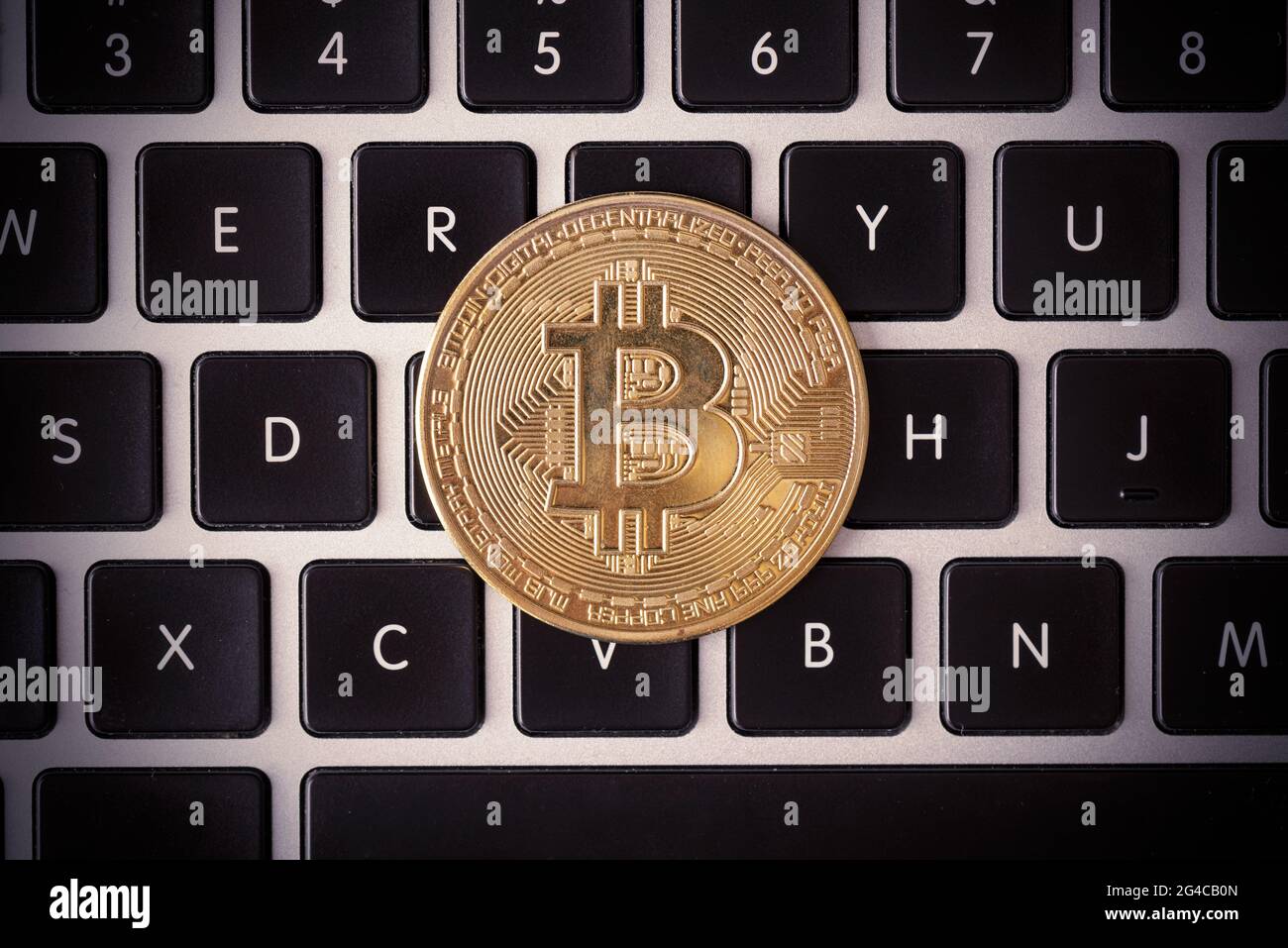 Golden coins with bitcoin symbol on laptop keyboard Stock Photo - Alamy