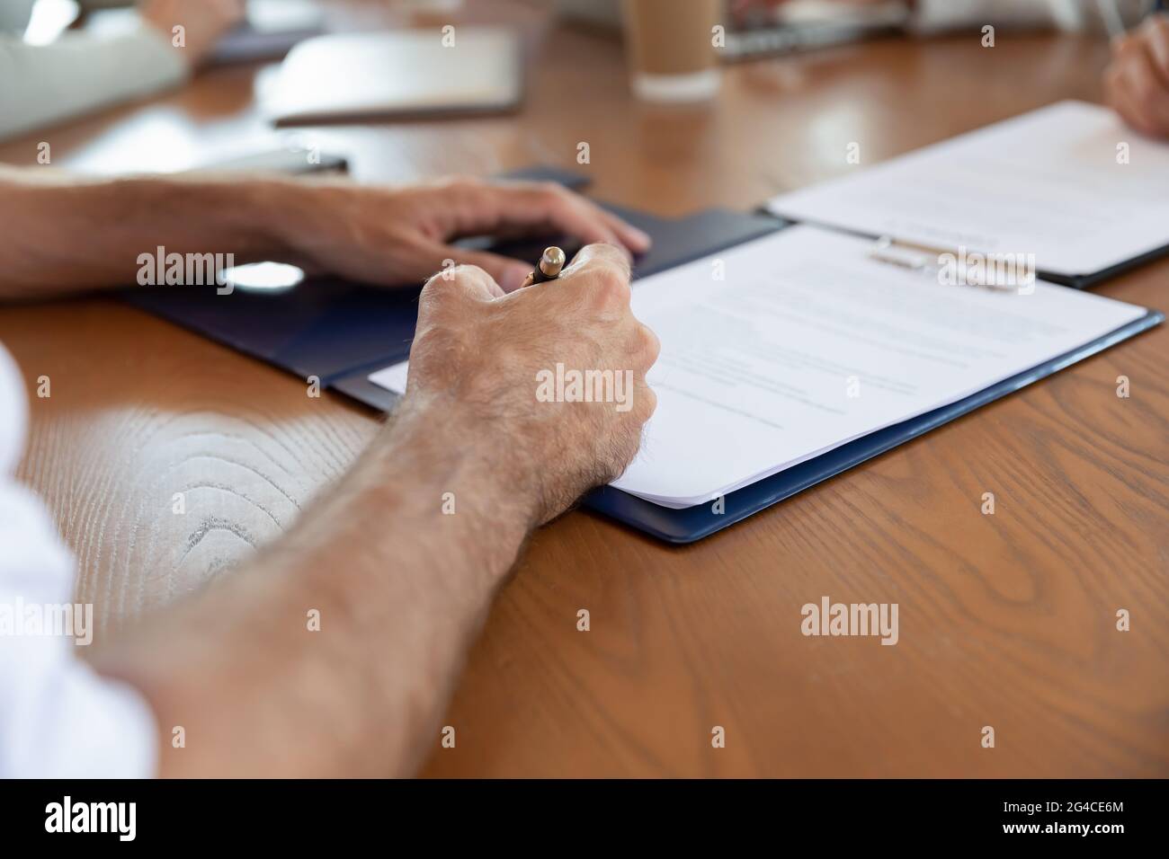 Close up businessman signing contract with pen at meeting Stock Photo ...