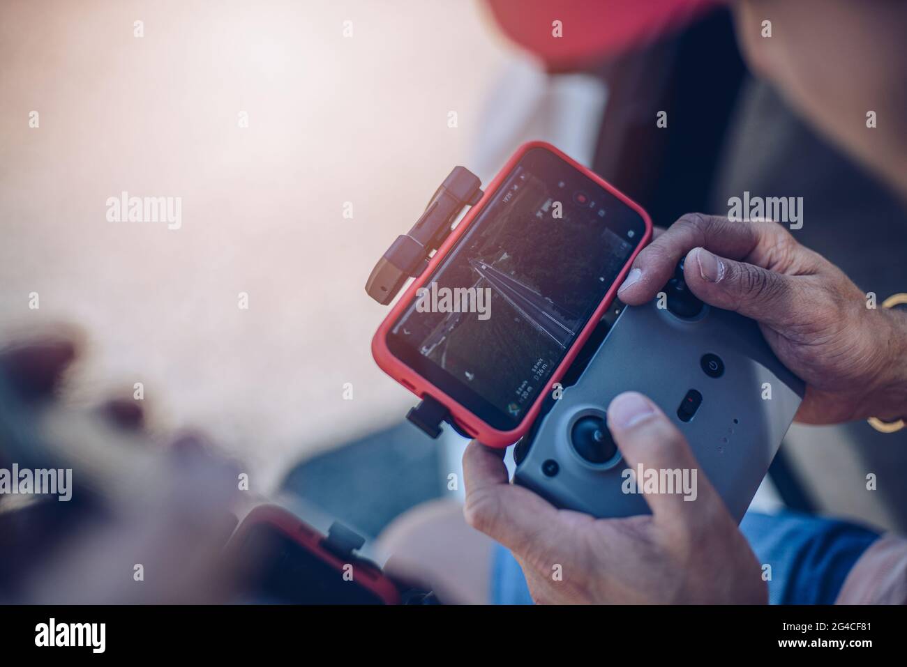 Man using remote control to operate his drone and taking photos Stock ...