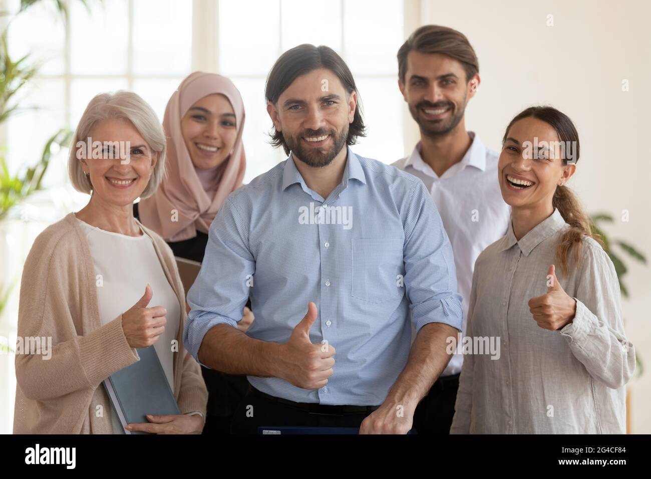 Group portrait of smiling multiethnic employees colleagues showing ...