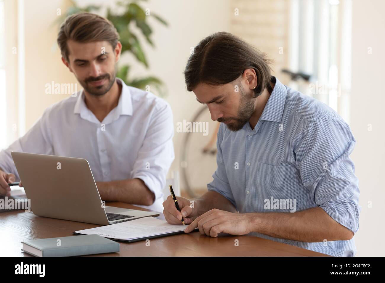 Focused client signing contract after successful negotiations with ...