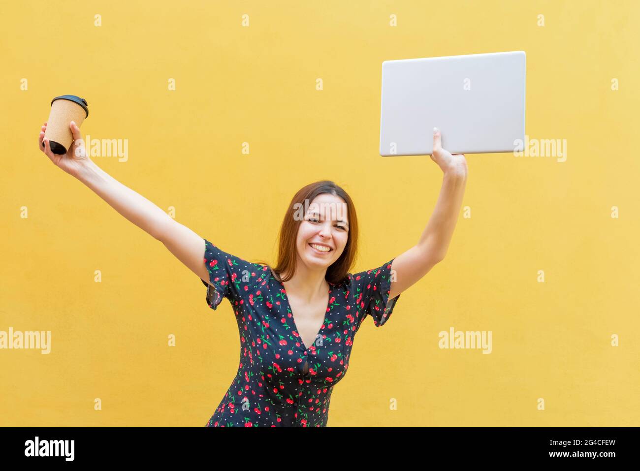 close up portrait of a young brunette woman isolated on yellow ...