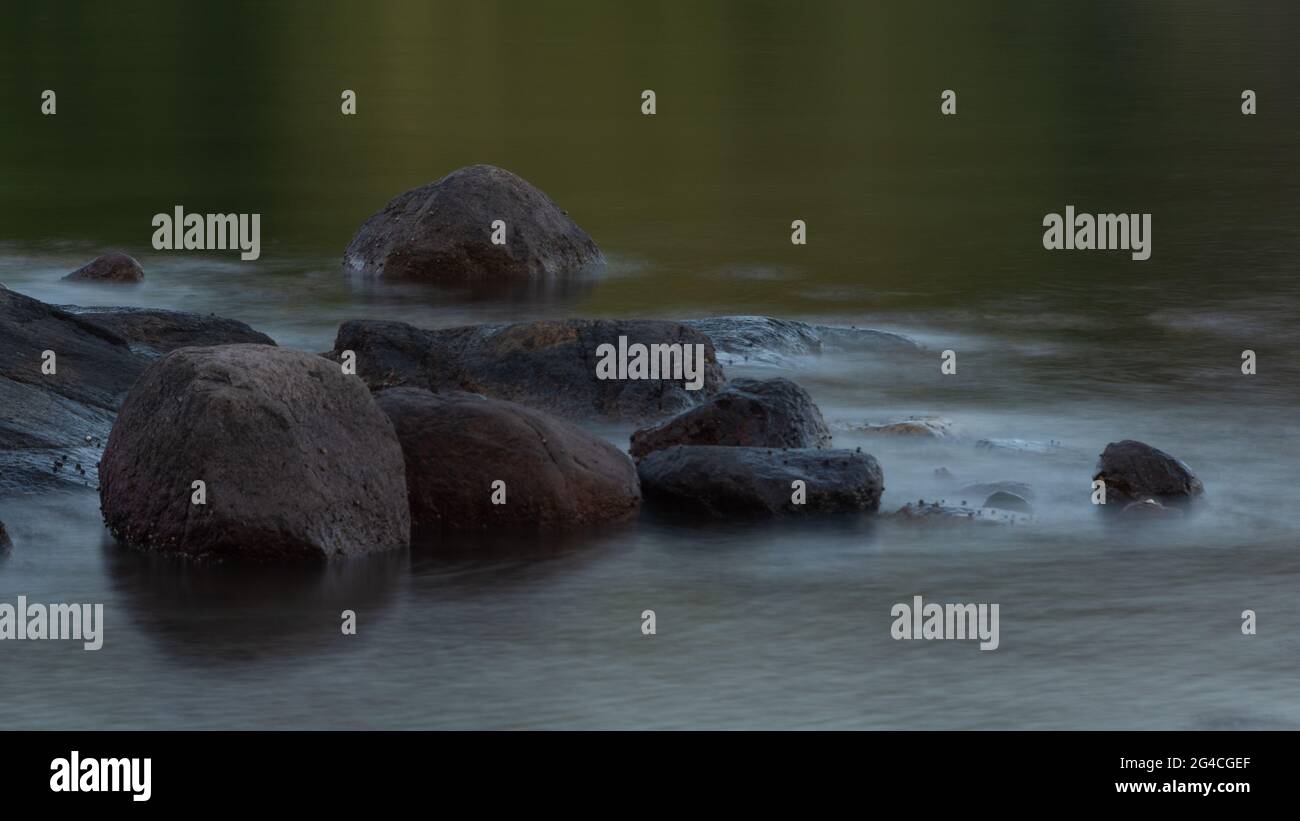 Water washes over rocks Stock Photo - Alamy