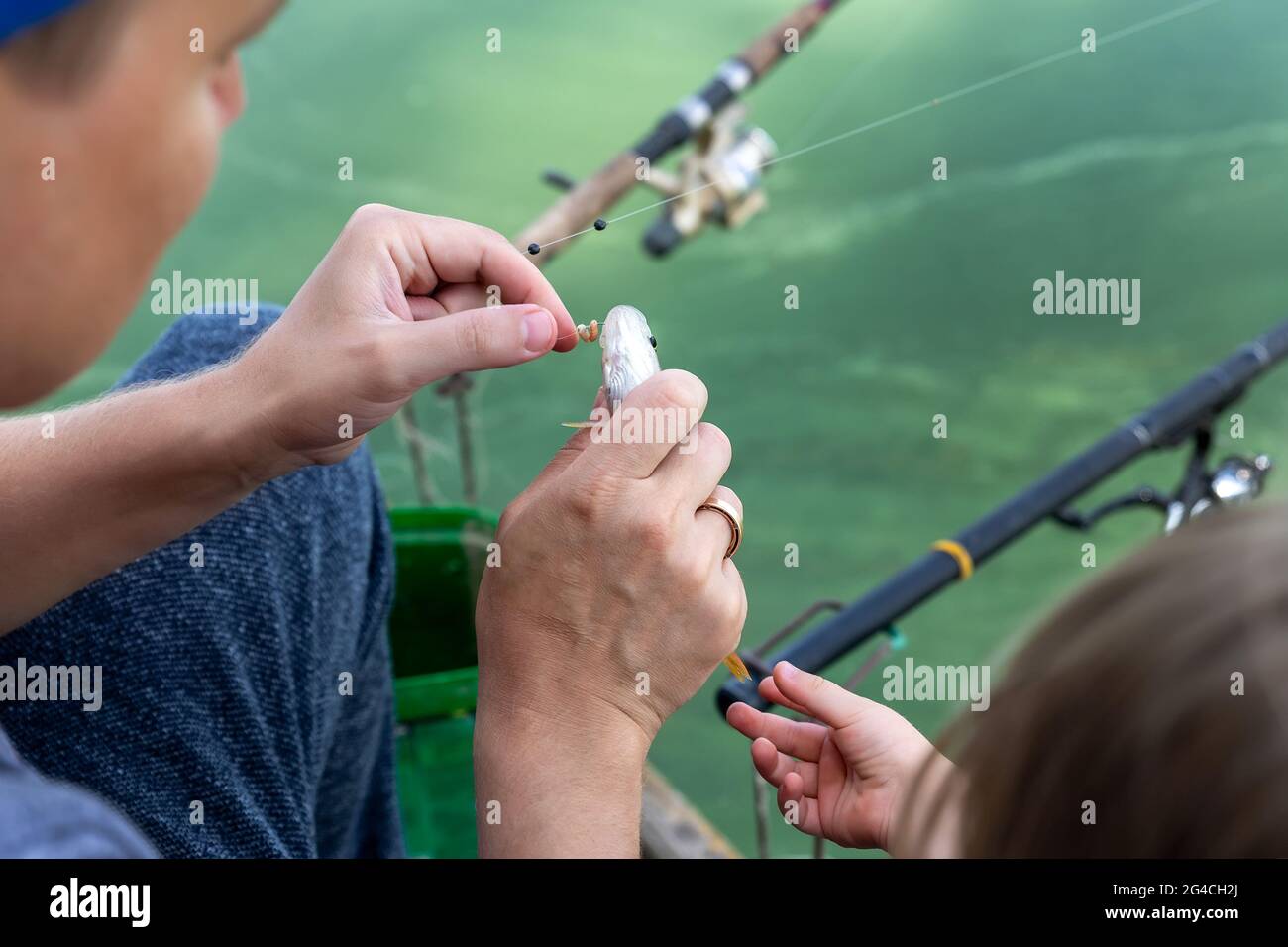 Young adult happy caucasian male angler person showing son extracting ...