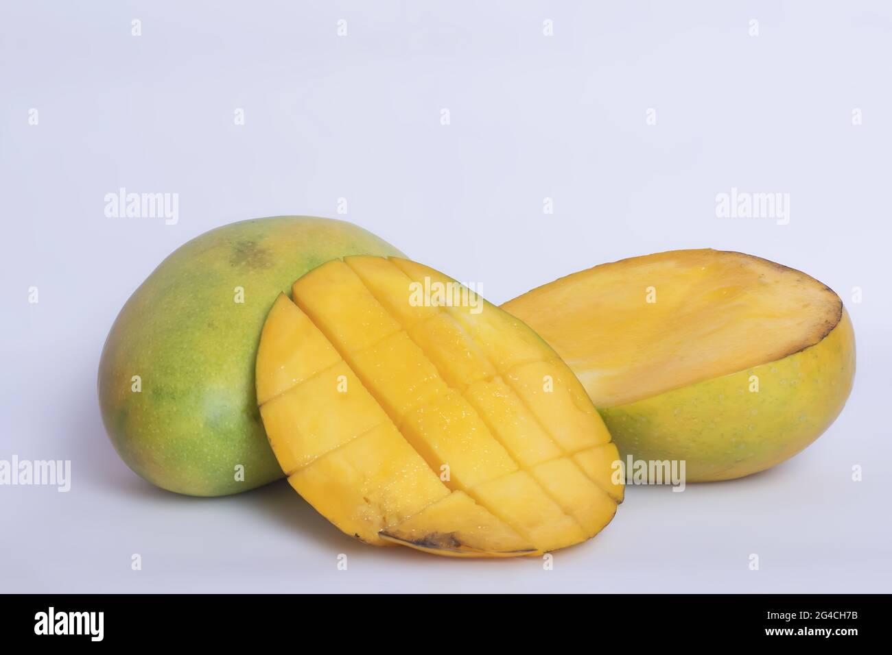 A full and cubed mango with a white background Stock Photo - Alamy