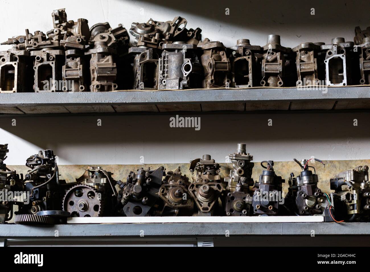 old dirty metal engine parts on dark garage shelf Stock Photo - Alamy