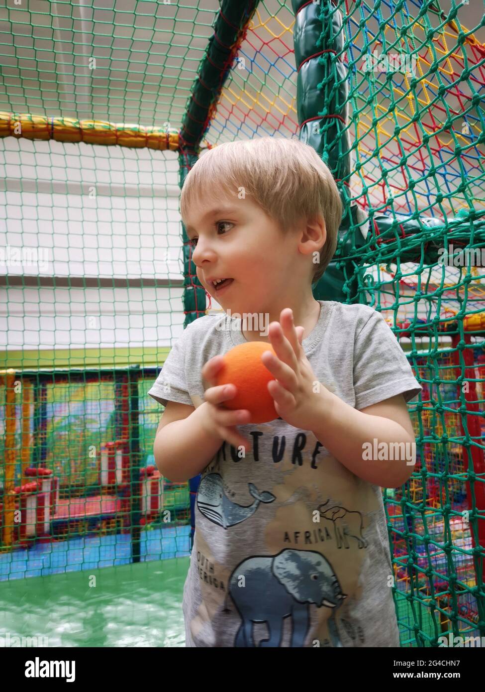 A vertical shot of a Caucasian boy playing in the playground Stock ...