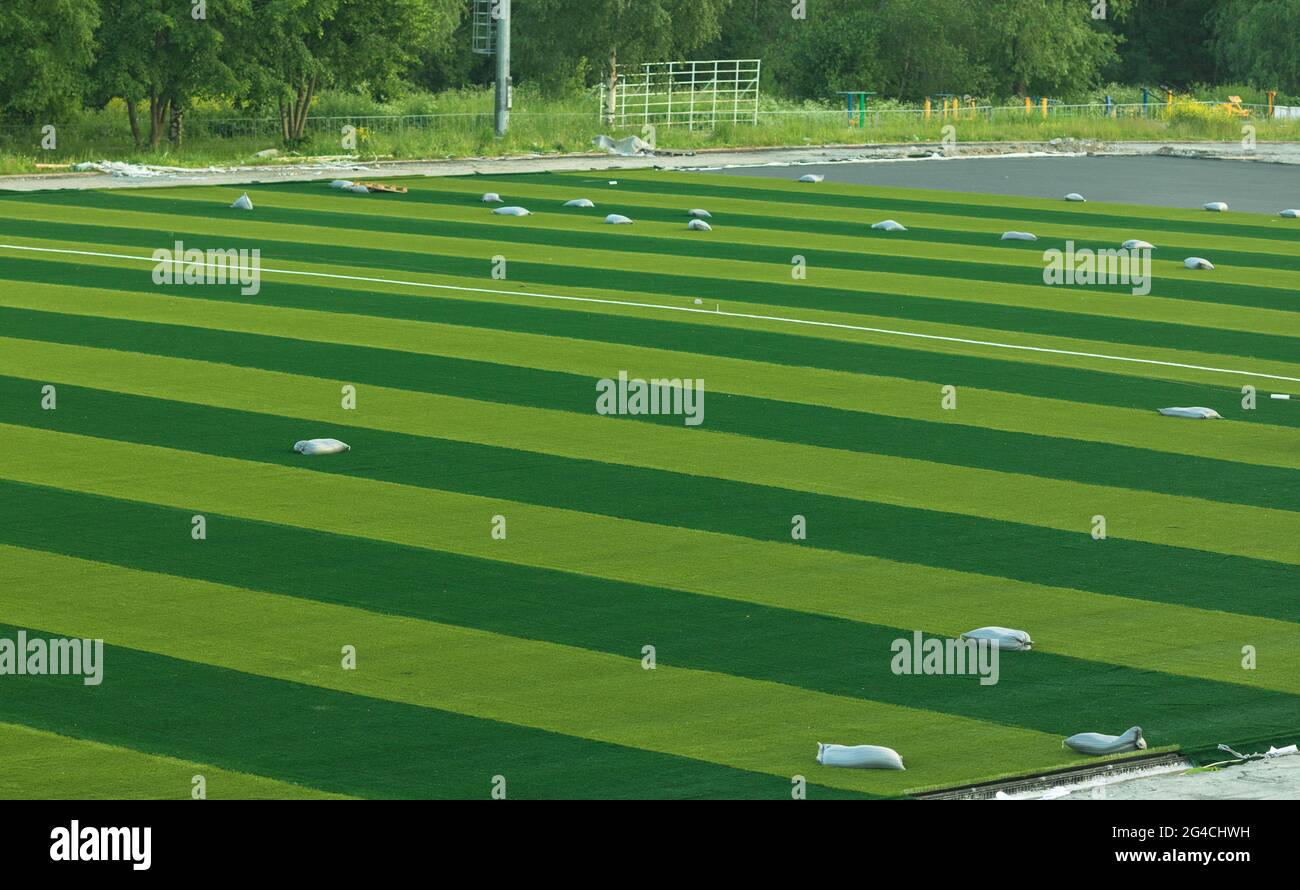 Repair of a football field, green turf for sports competitions, soccer ...