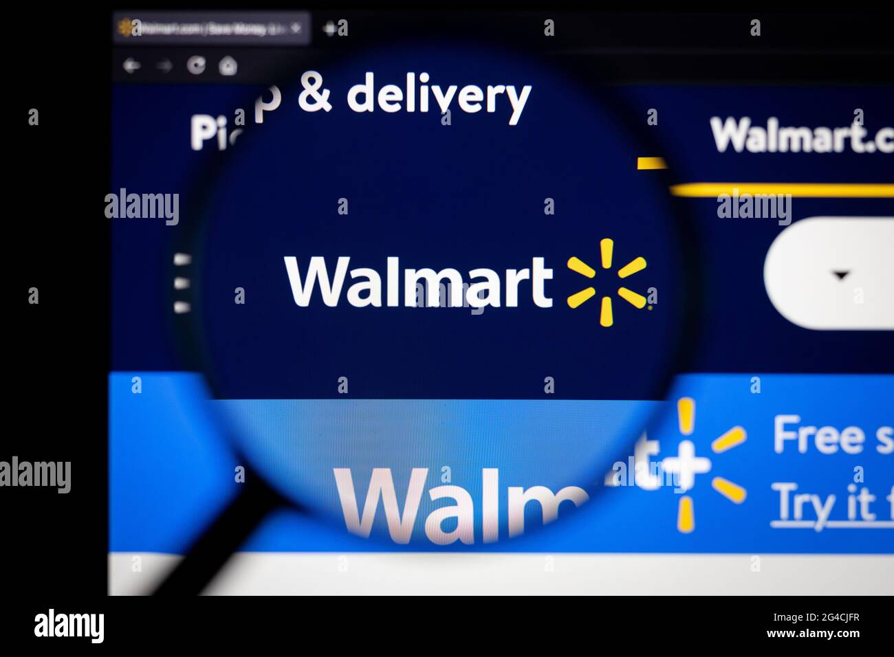 Walmart company logo on a website seen on a computer screen through a ...