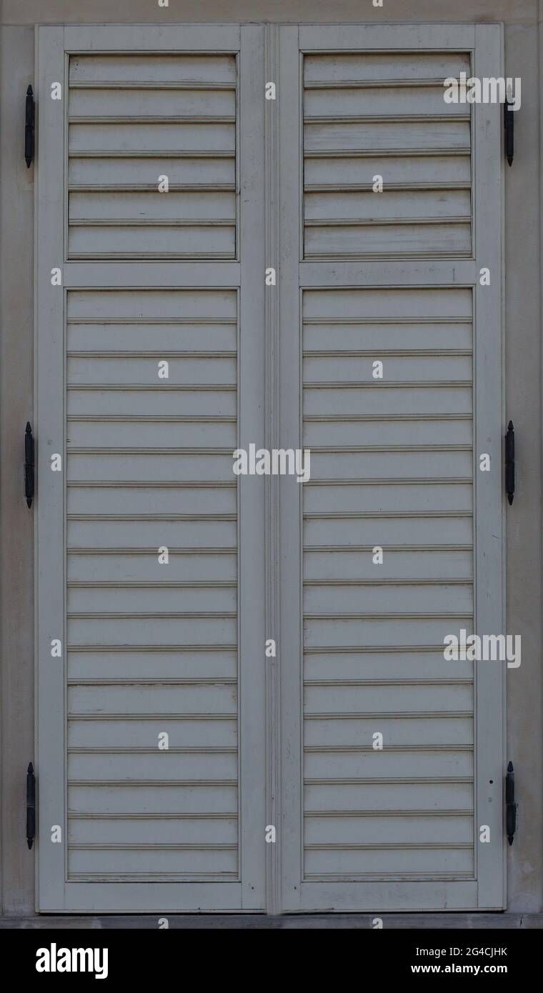 Wooden shutters and a window with closed shutters. Bright old fashioned ...