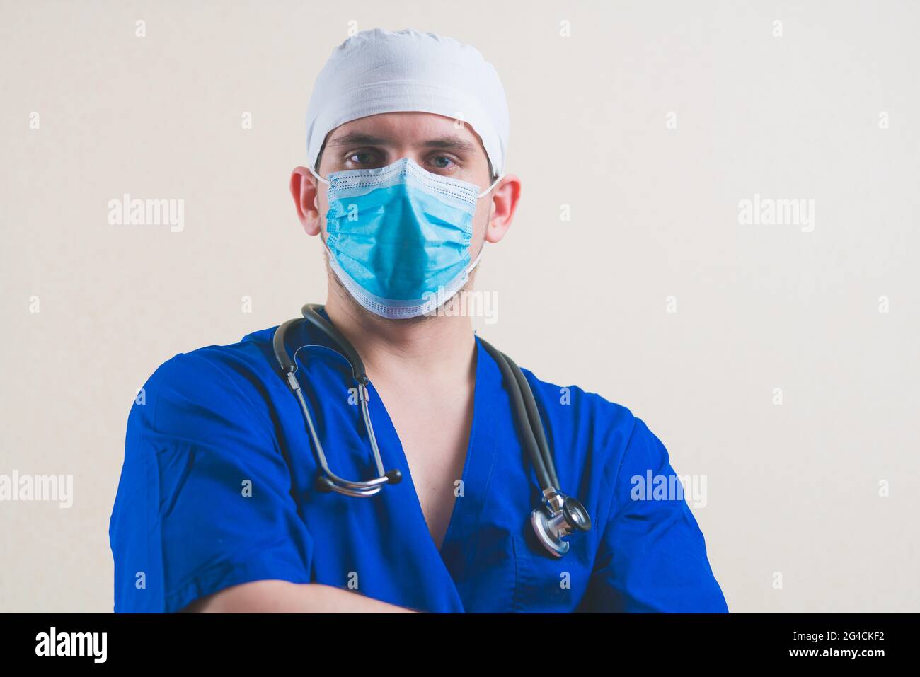 Young doctor portrait in blue suit, stethoscope and protective ...