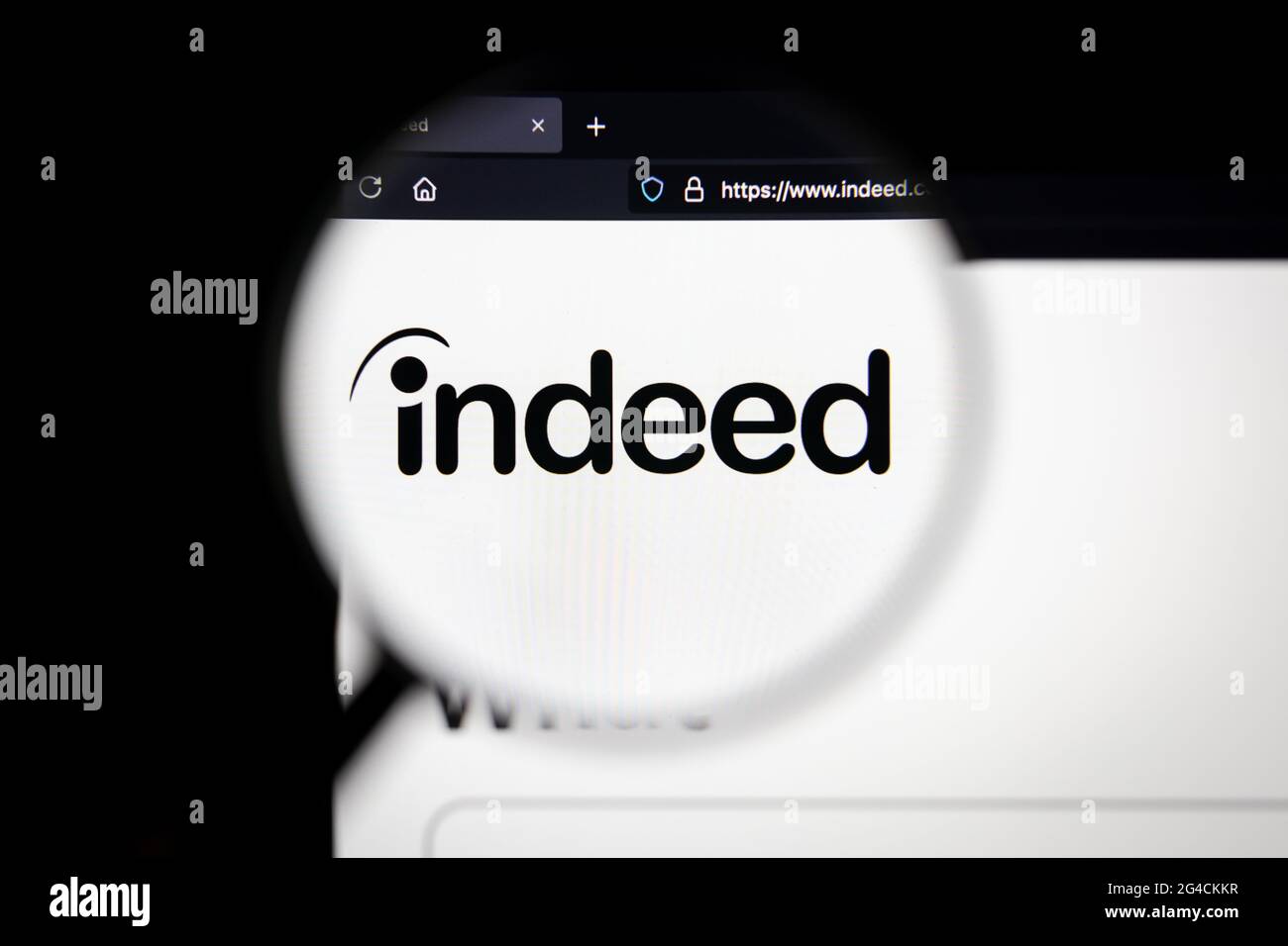 Indeed company logo on a website seen on a computer screen through a ...