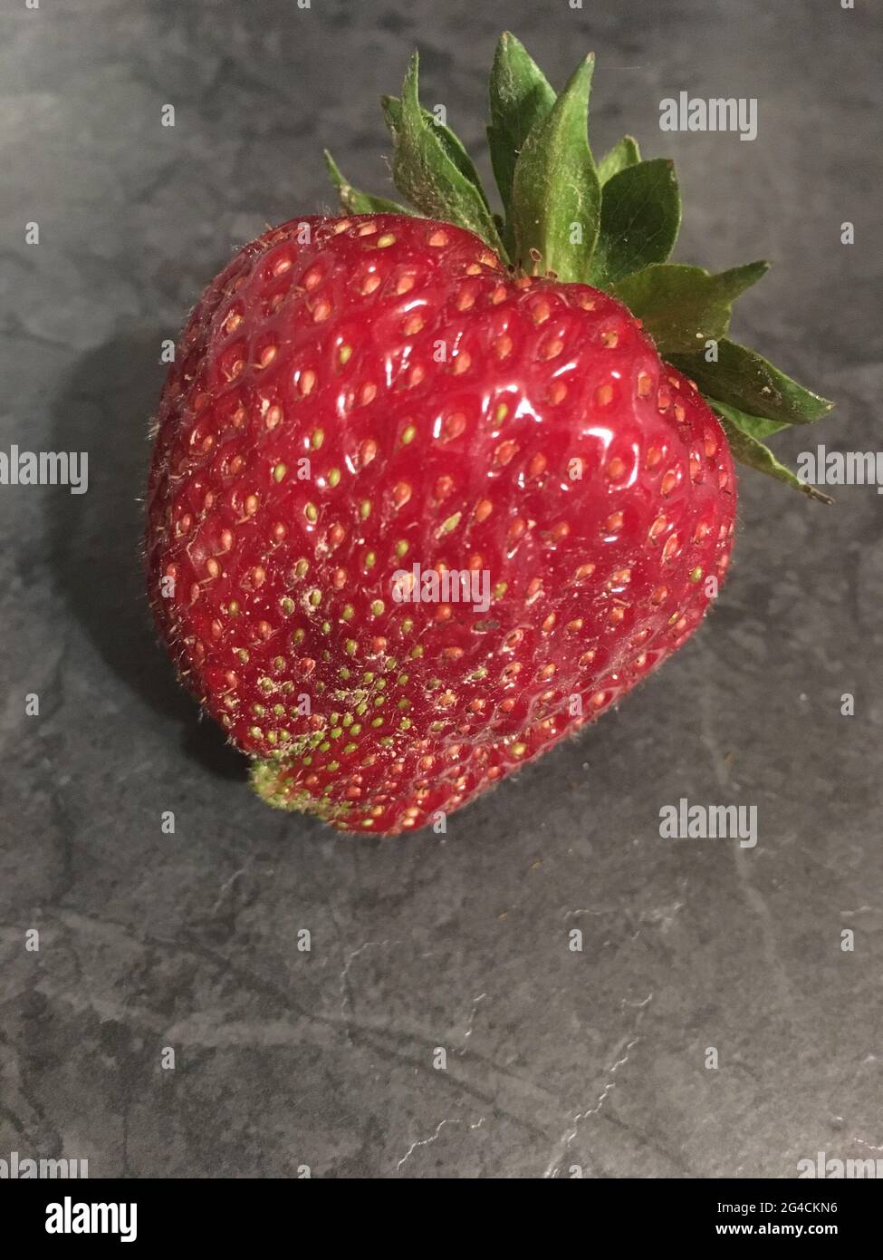 Red ripe strawberry berry on black background Stock Photo - Alamy