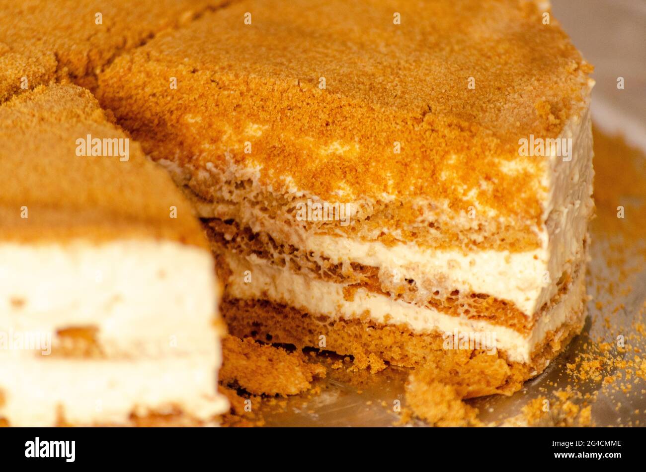 A closeup shot of a cut French honey cake piece on the table Stock ...