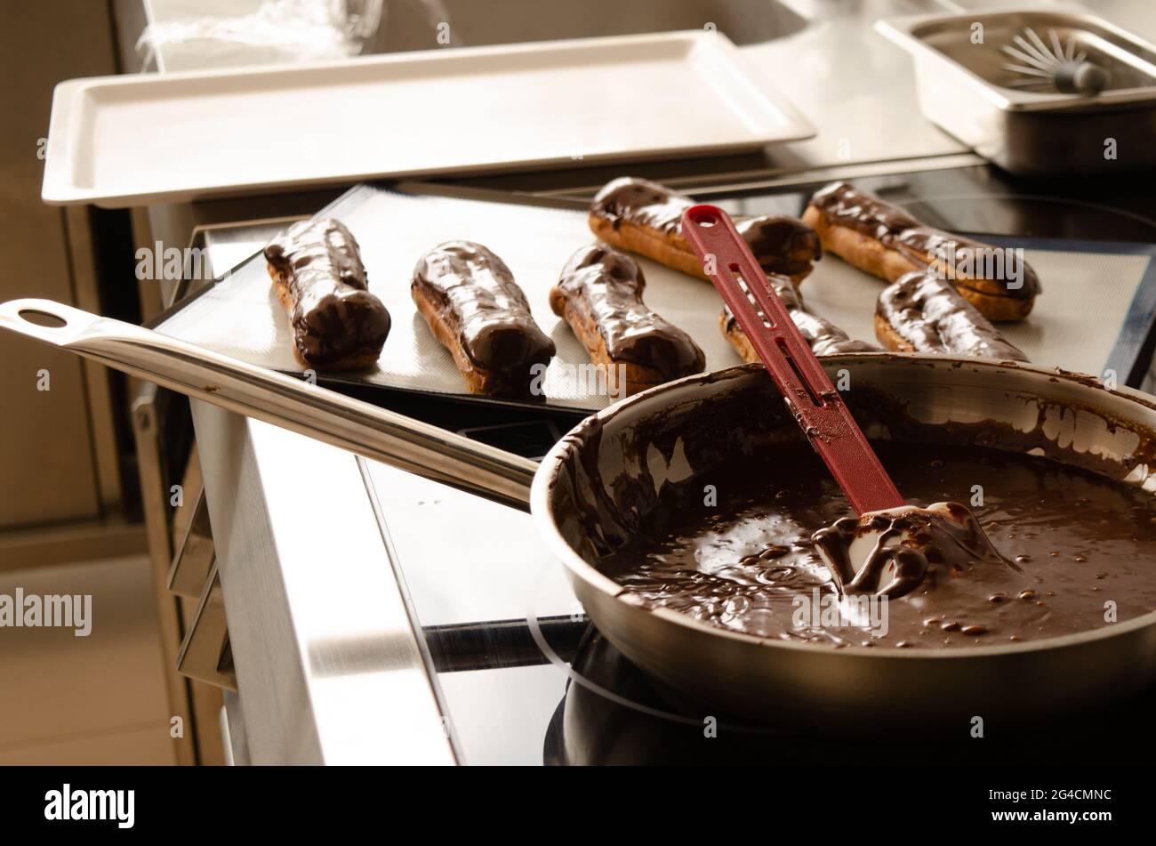 The process of making classic chocolate eclairs - melted chocolate in a ...