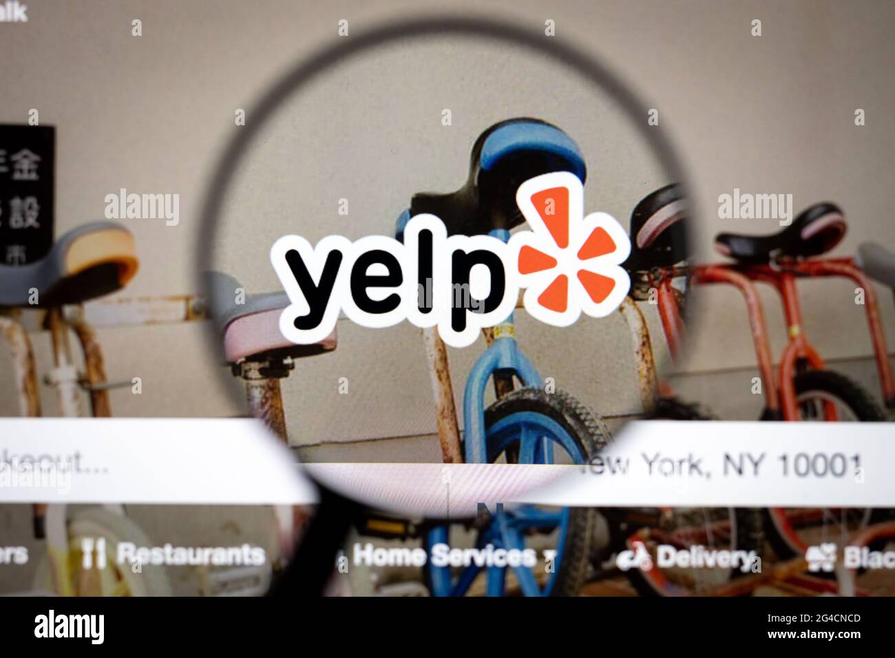Yelp company logo on a website, seen on a computer screen through a ...
