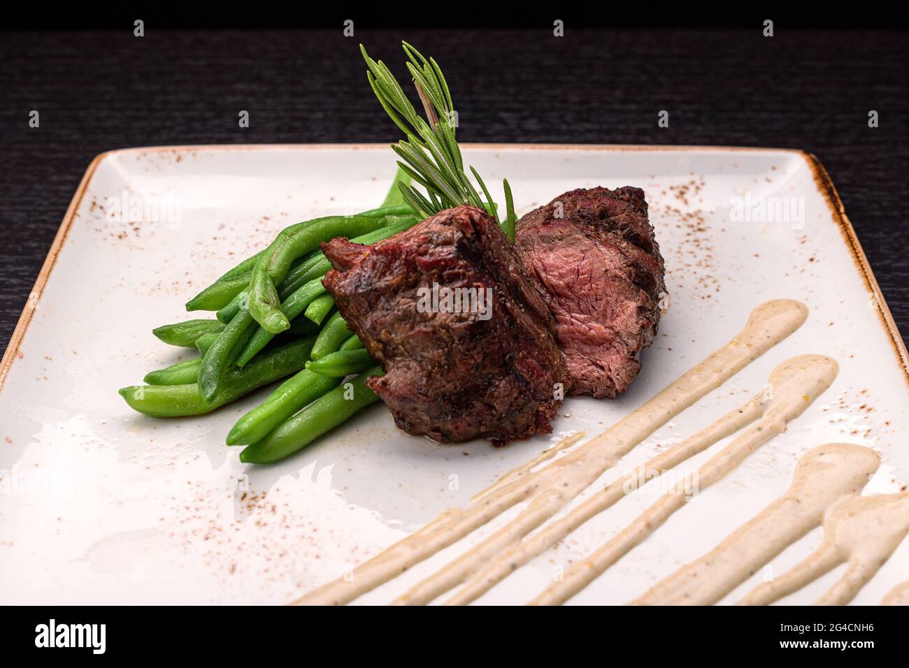 Filet mignon with asparagus on a light plate Stock Photo - Alamy
