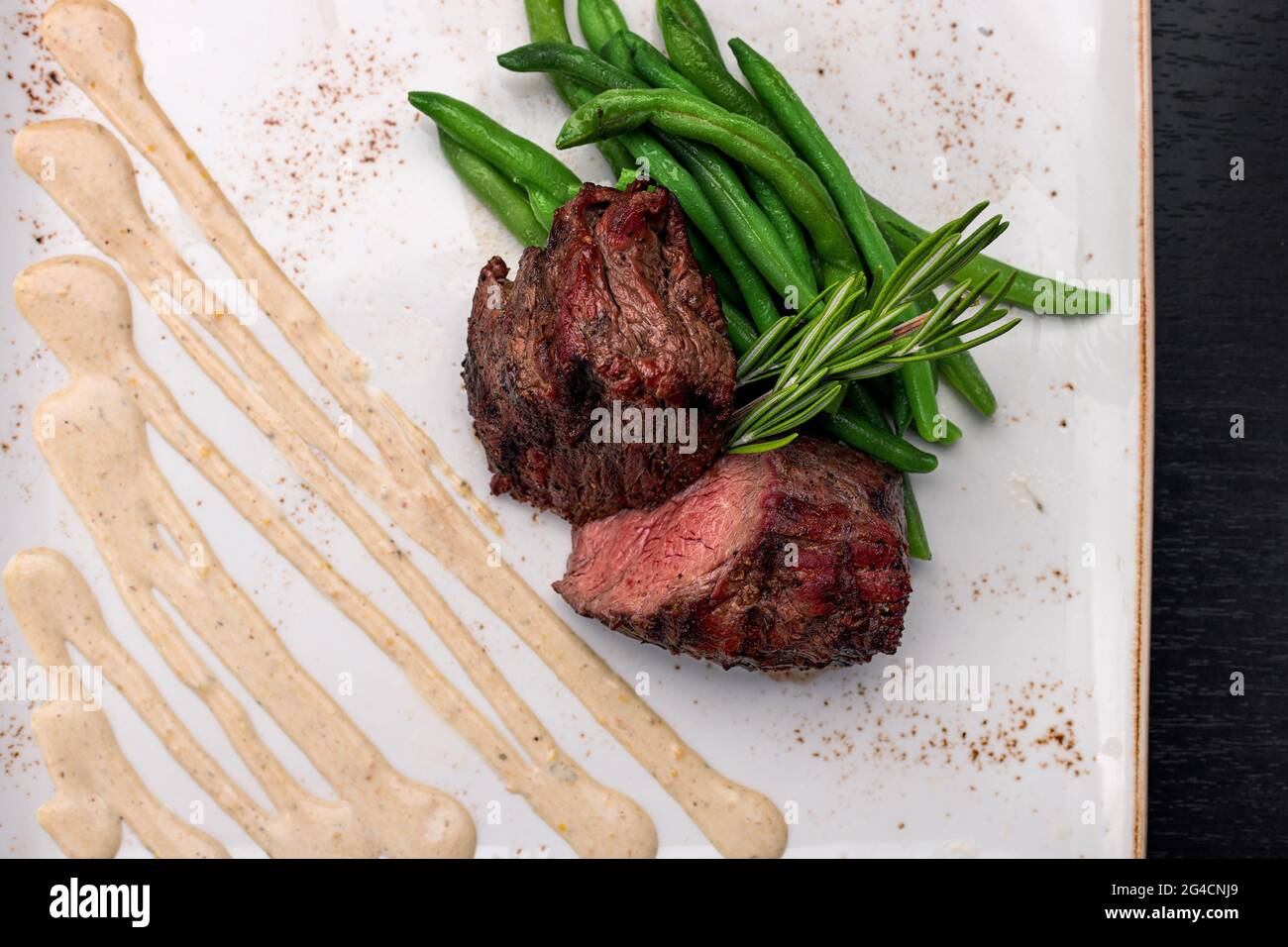 Filet mignon with asparagus on a light plate Stock Photo - Alamy