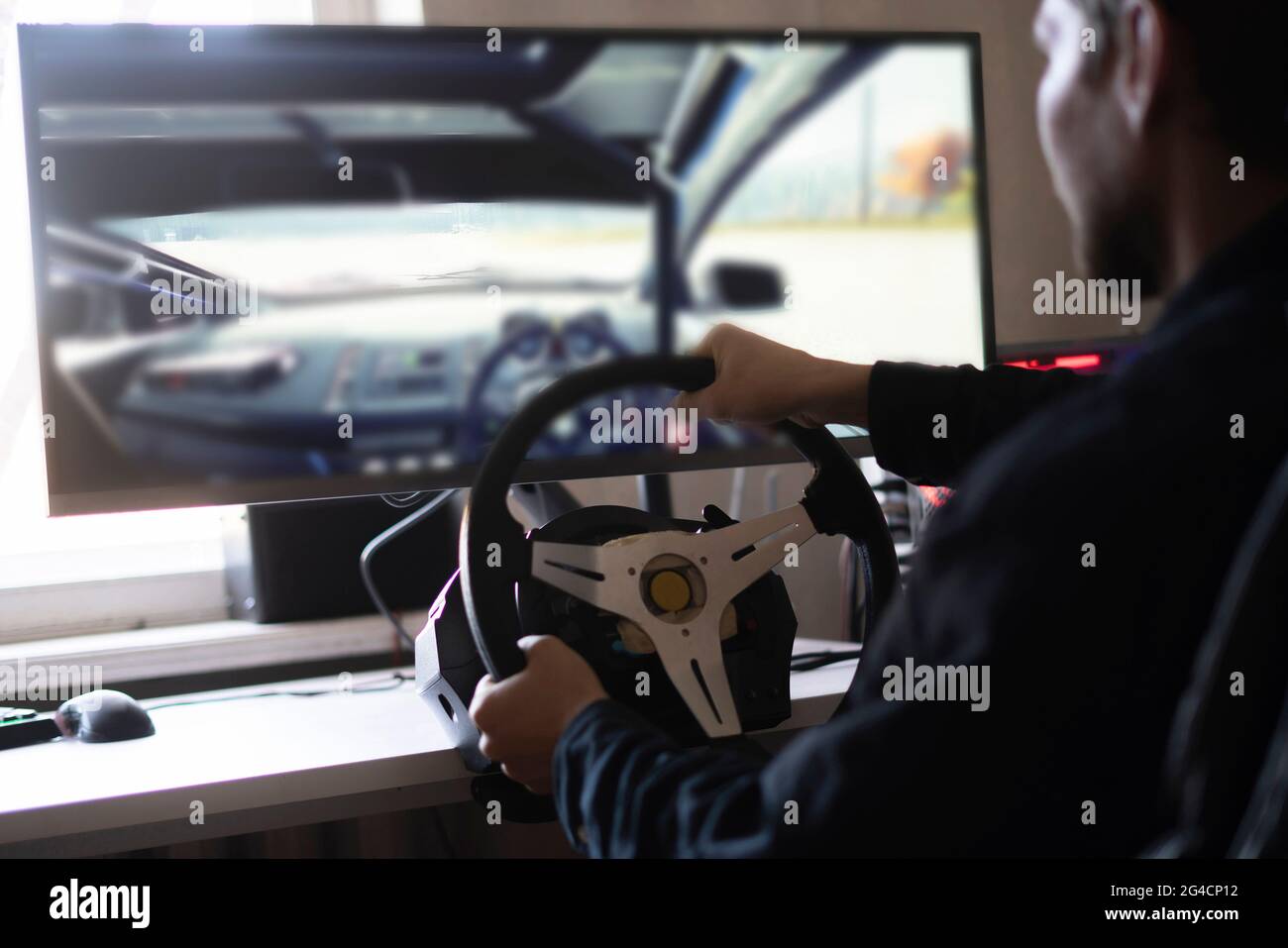 person learns how to drive the car using an auto computer simulator ...