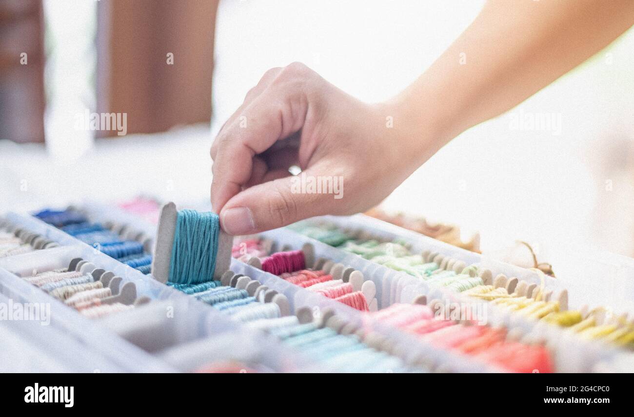 Hands holding colorful string hi-res stock photography and images - Alamy