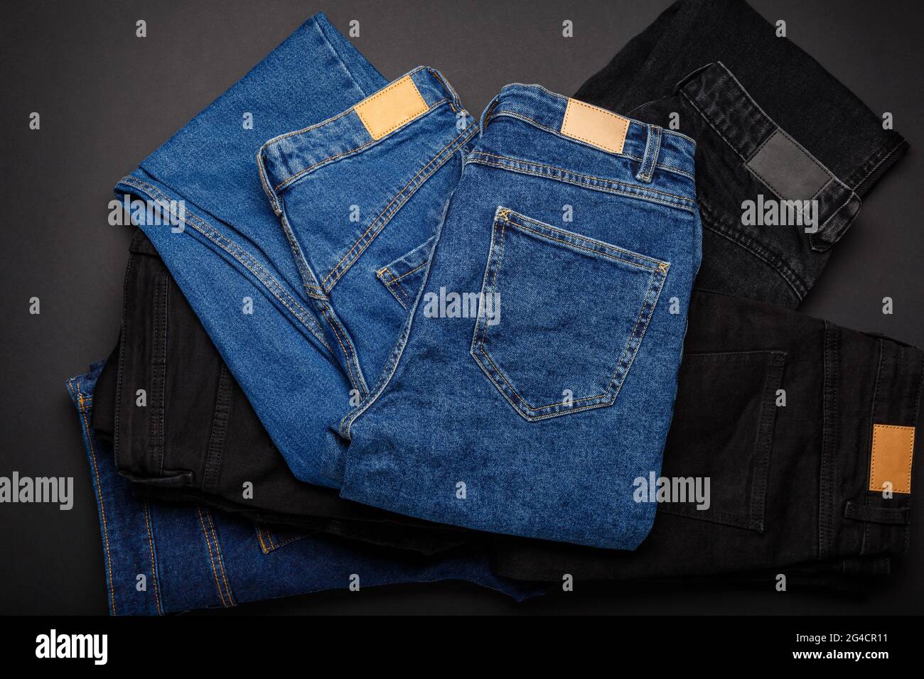 Blue denim jeans on pile of jeans pants. Top view of variety of denim ...