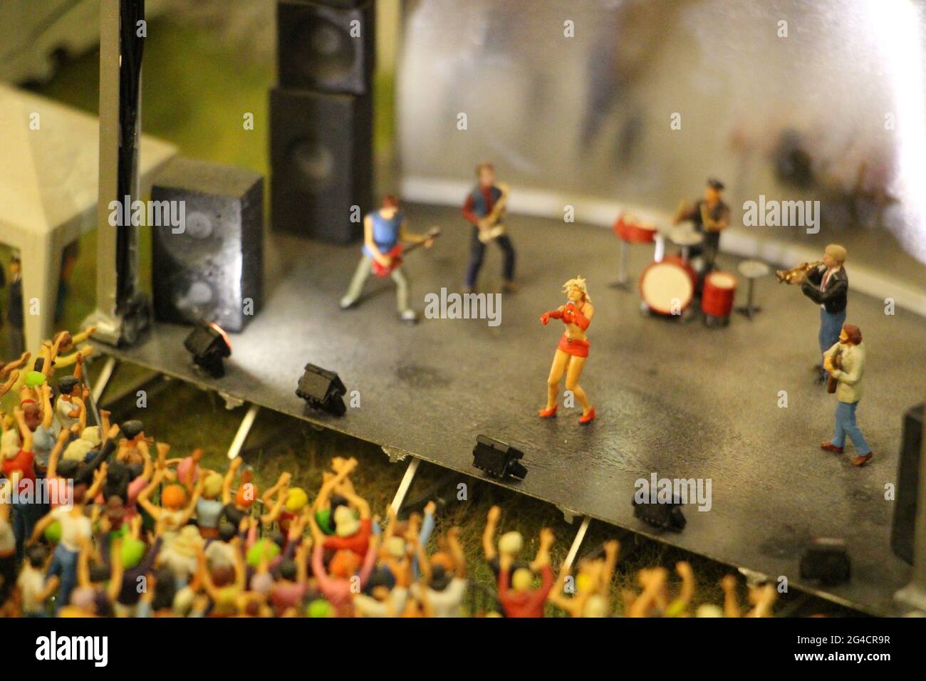 A selective focus shot of a mini toy stage with little figures ...