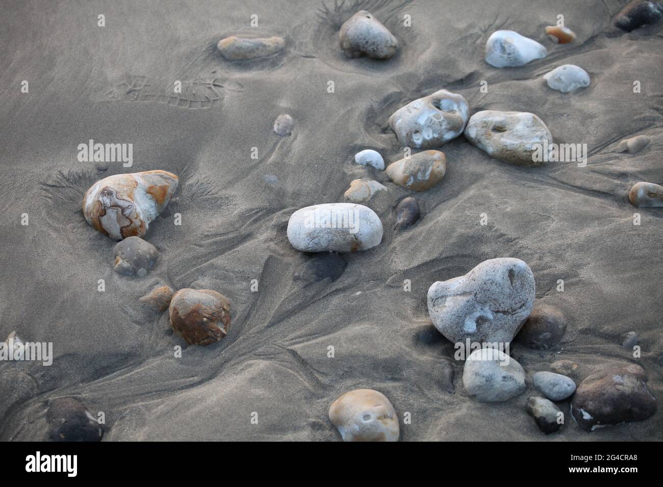 Closeup of rocks on the sand in the daylight - perfect for wallpapers ...