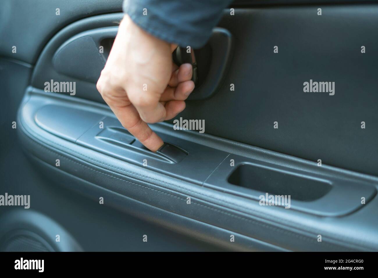 person sitting inside the car and open the window, finger push the ...