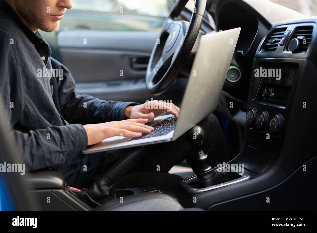 car mechanic doing auto diagnostic using computer, searching for check ...