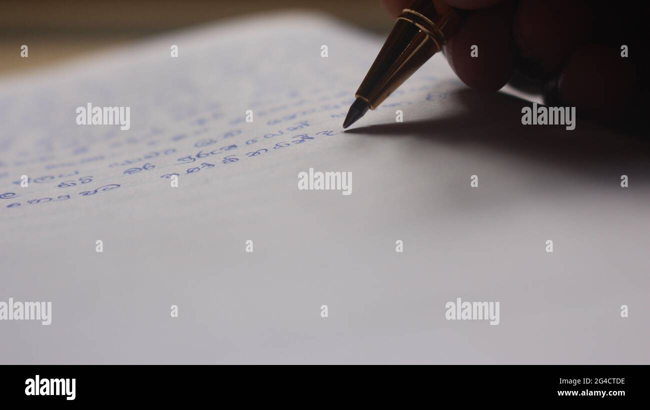 Close up picture of a writting a word with a ink pen with a blurry ...