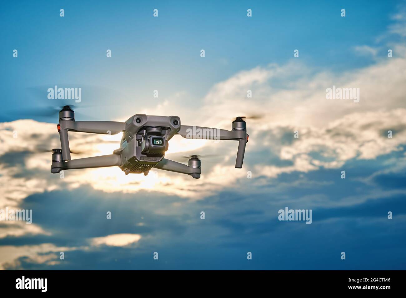 Modern drone with camera in the sky. Flying quadcopter Stock Photo - Alamy