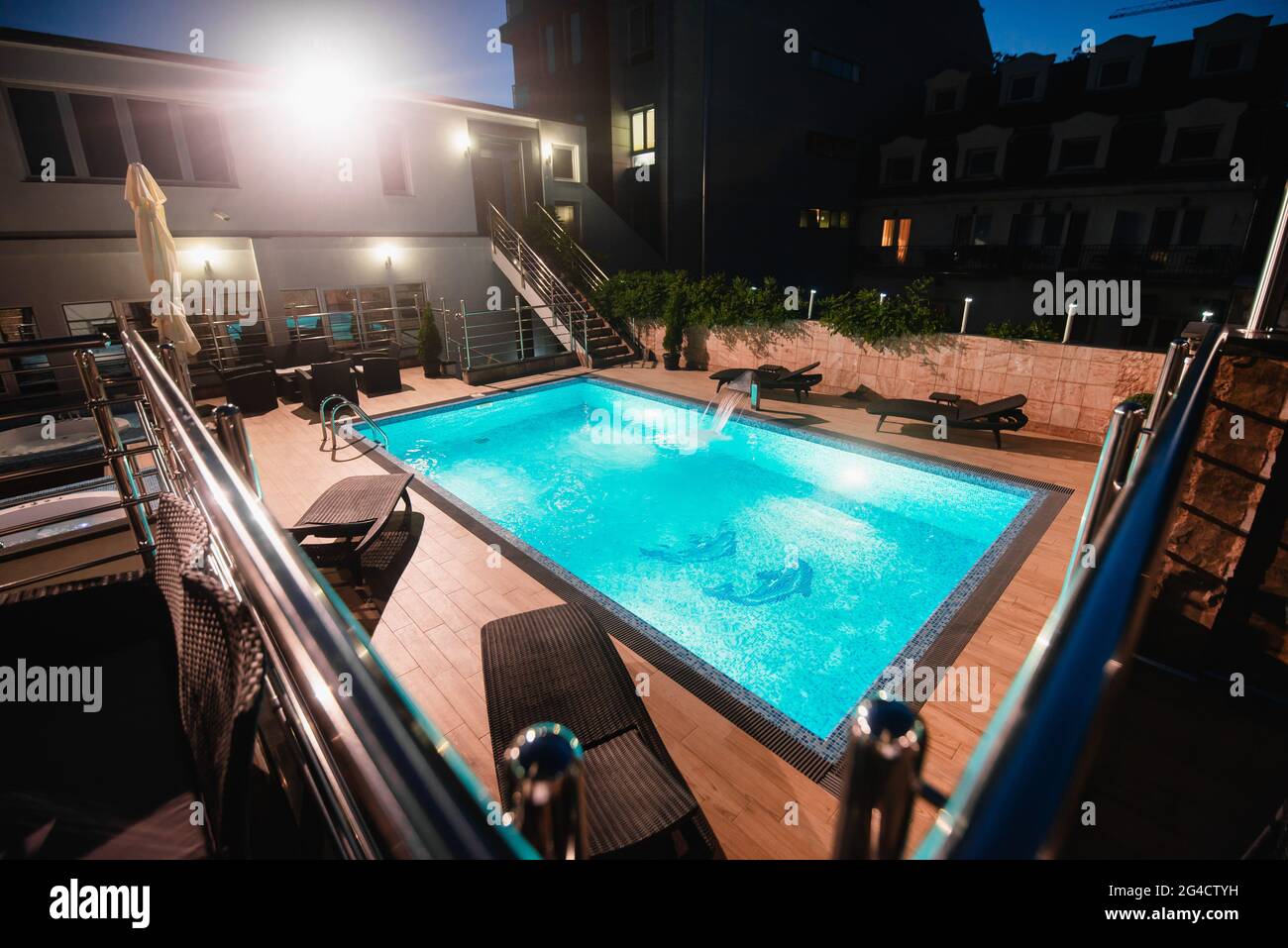 Swimming pool with stair and wooden deck at hotel Stock Photo - Alamy