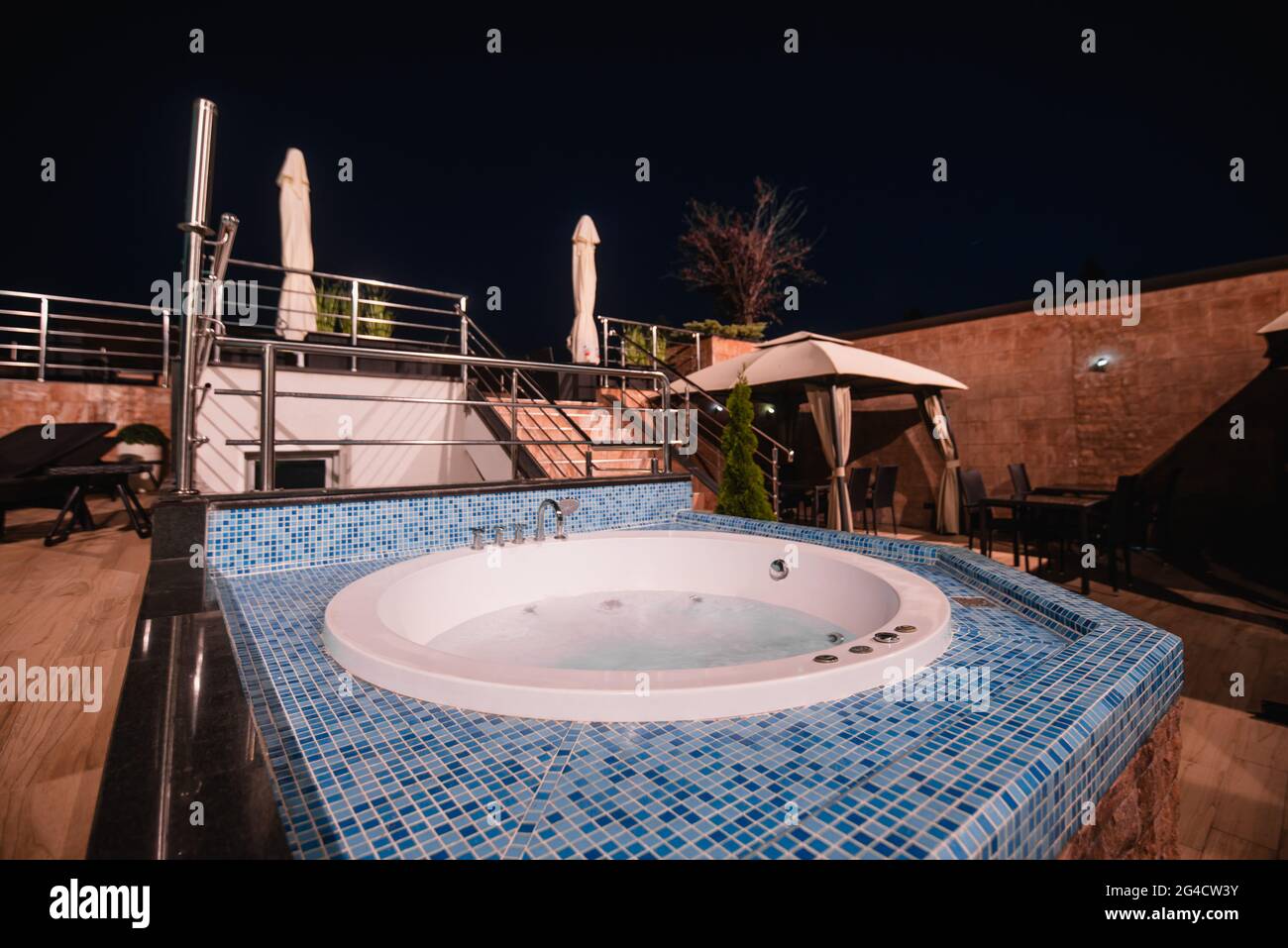 Small hotel pool at night Stock Photo - Alamy