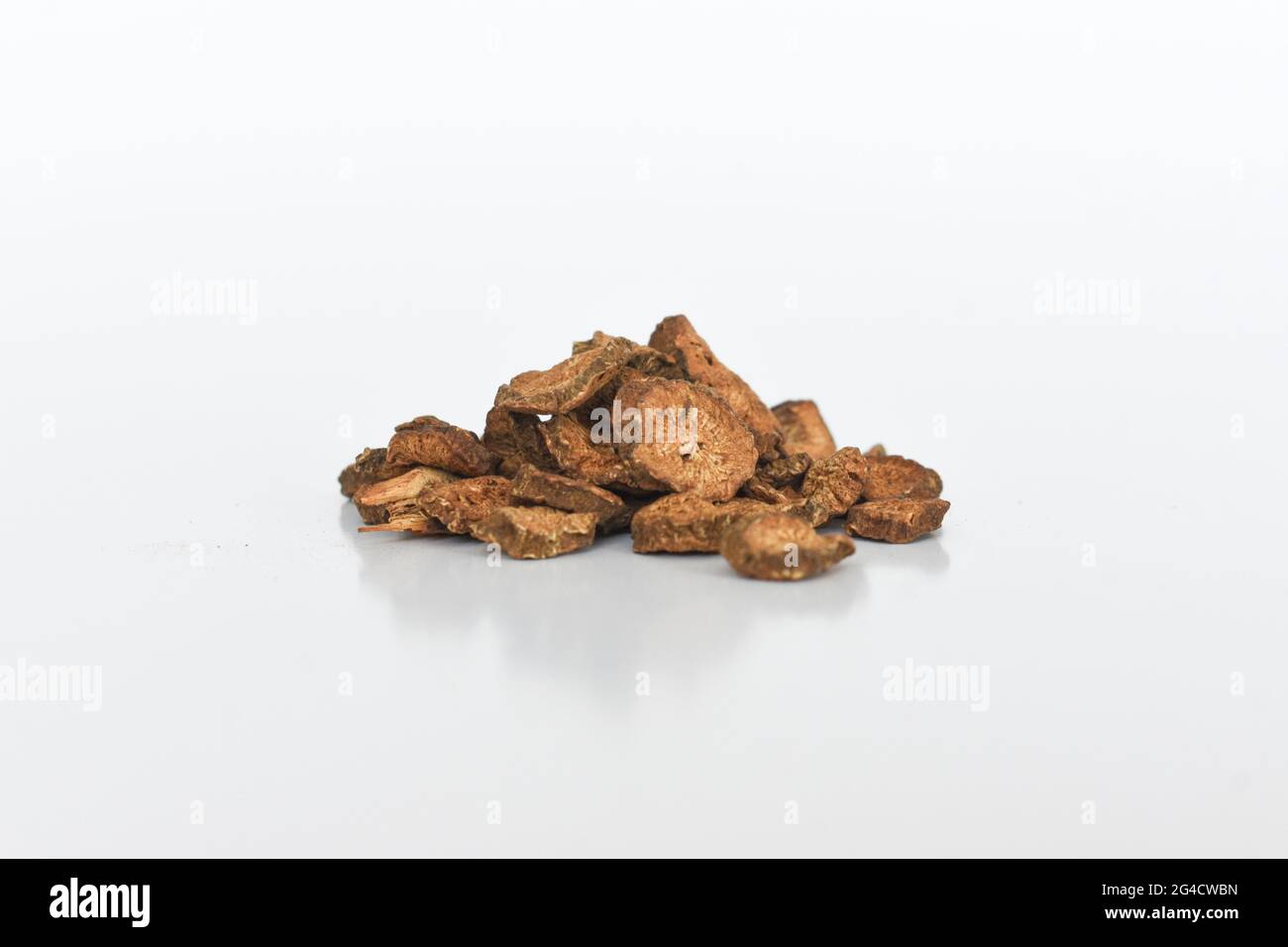 Dried burdock roots on isolated white background Stock Photo - Alamy