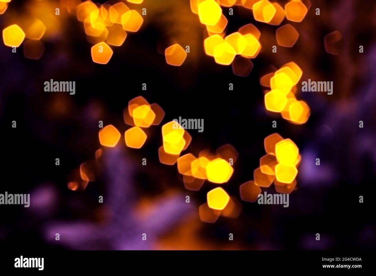 Blurred golden lights abstract background in the night, defocused dark ...