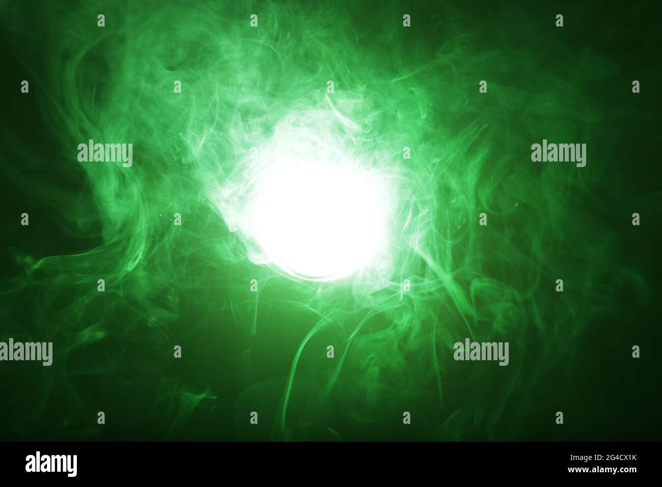 Smoke in green light on black background Stock Photo - Alamy