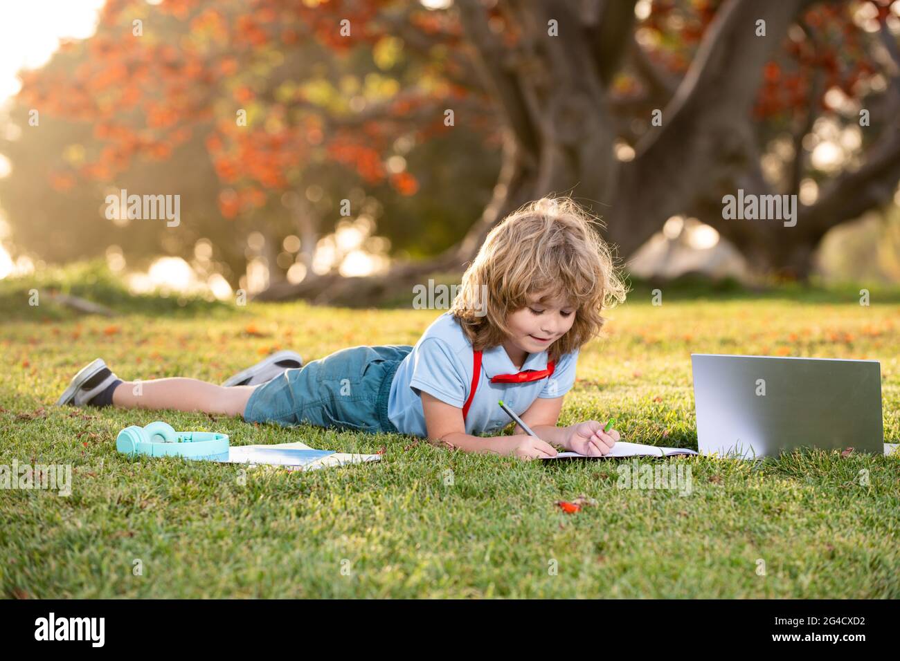 Boy doing homework outside hi-res stock photography and images - Alamy