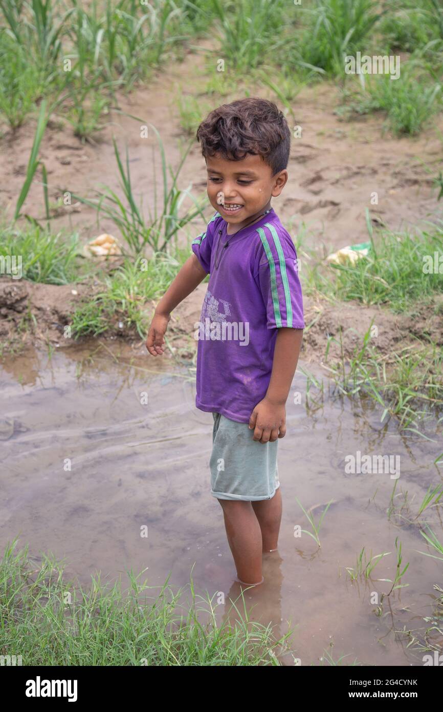 Poor Indian child standing rice paddy filed in outdoor background Stock ...