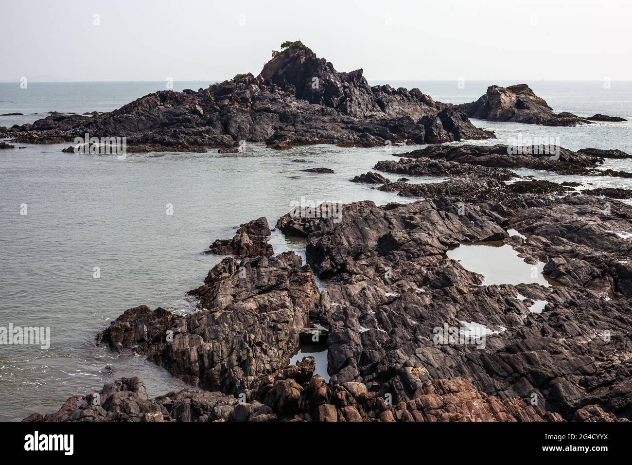 Natural black rock formation in the sea at Om Beach, Gokarna, Karnataka ...