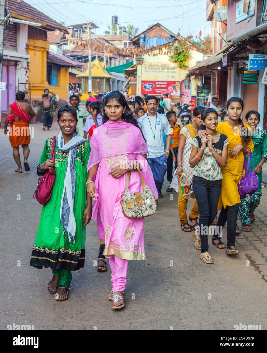 Two attractive girls fronting the large group of Indian schoolchildren ...