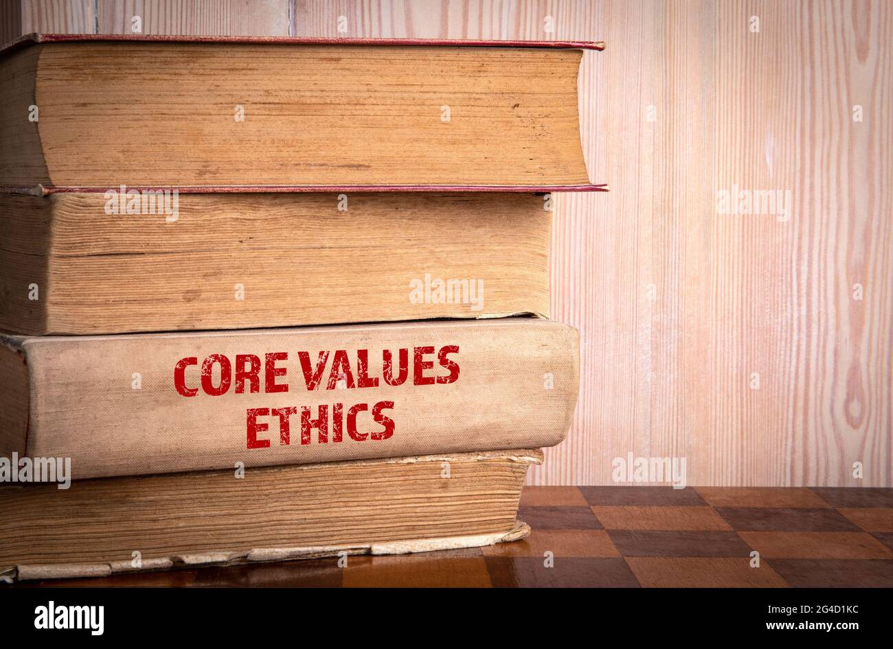 Core Values and Ethics. Stack of old books on a wooden background Stock ...