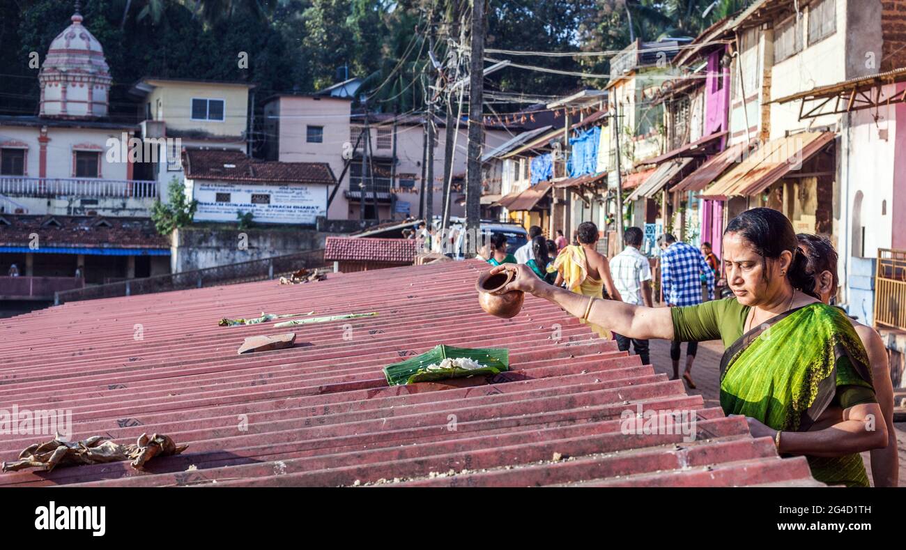 Indian female offers food to the birds representing the departing of ...