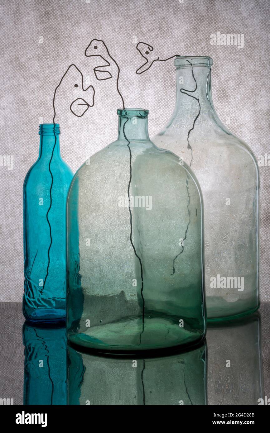 Still life with glass bottles and the silhouette of a human head made ...