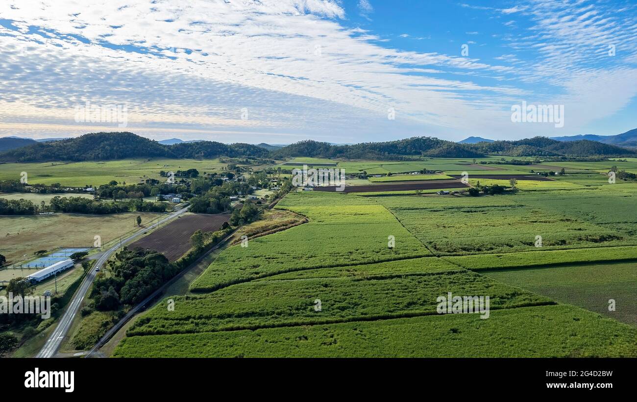 Aerial view of a farming countryside and small village under a cloudy ...
