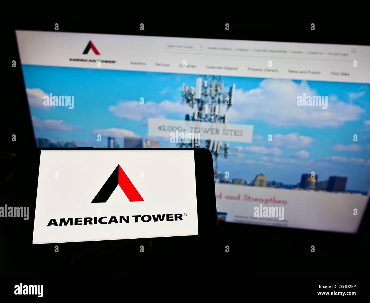 Person holding mobile phone with logo of American infrastructure ...