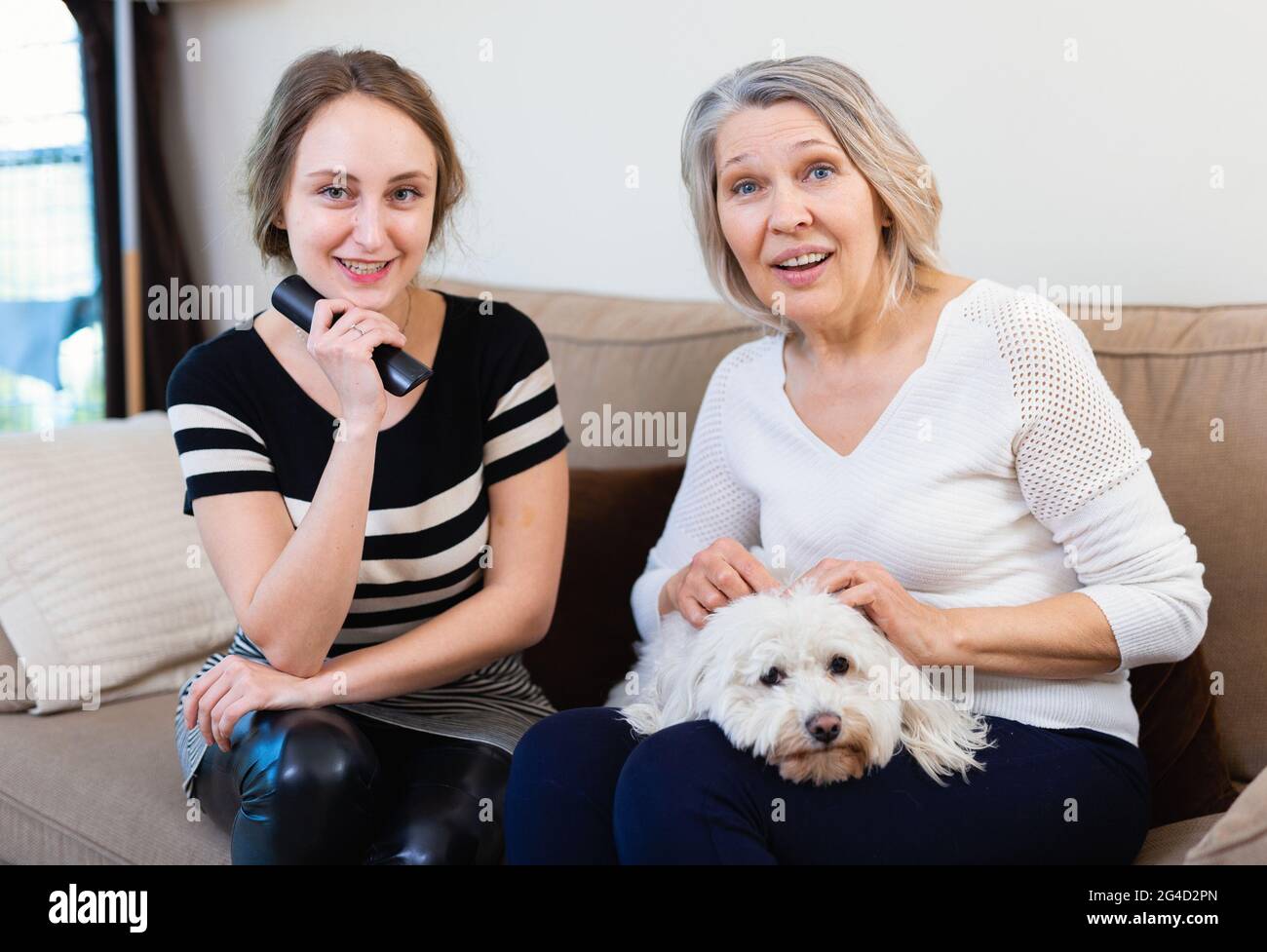 Two women watching TV Stock Photo - Alamy