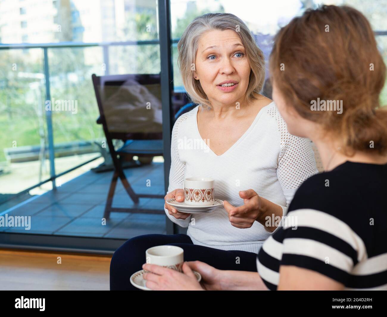 Two women talking at home Stock Photo - Alamy