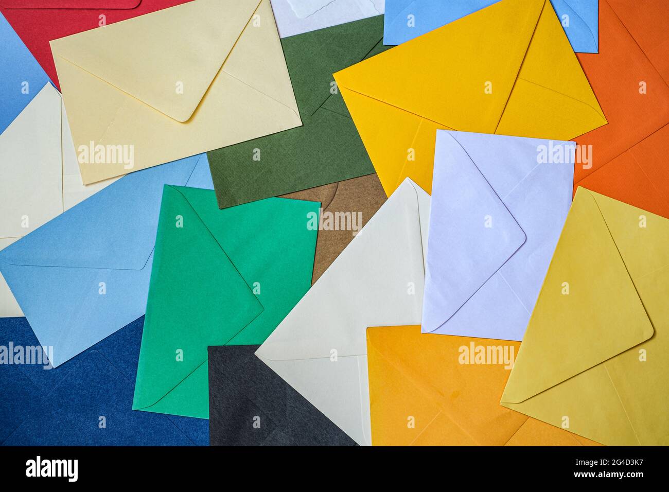 Different colored envelopes on the table Stock Photo - Alamy