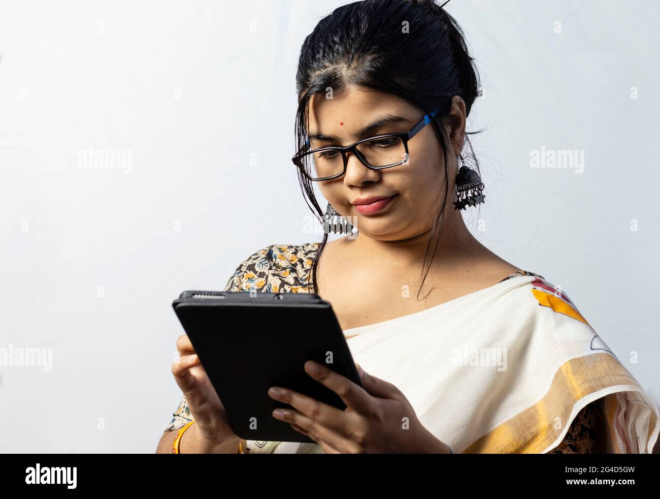 Isolated on white background an Indian office woman in saree working on ...
