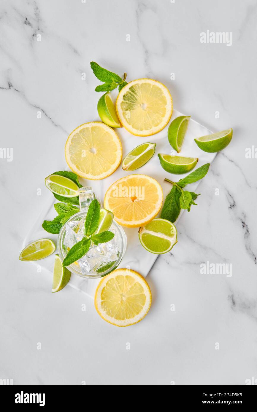 Overhead view of glass with lemon, lime and mint cold lemonade on ...